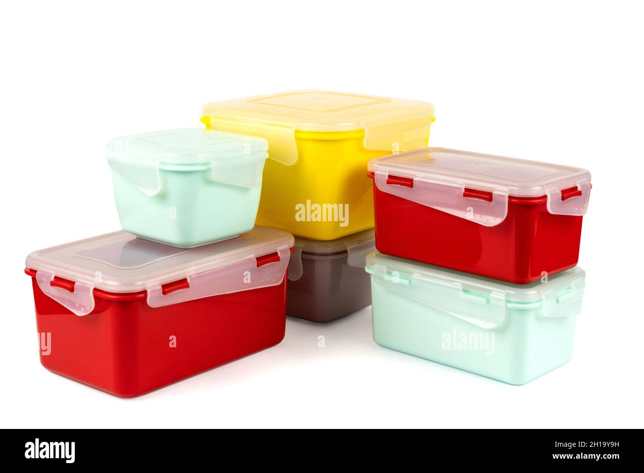 Multicolored plastic lunch boxes folded at corner on white background ...