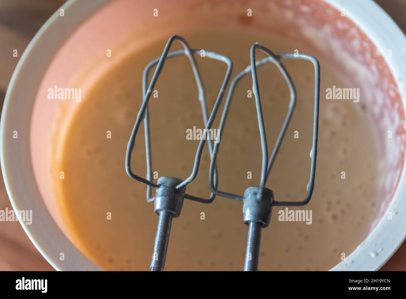 A closeup shot of a mixer near pot with mixed cream Stock Photo - Alamy