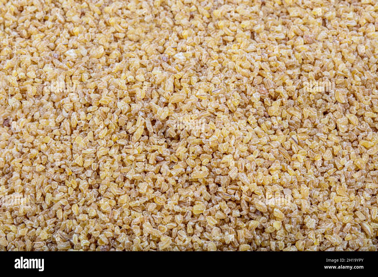 Pile of bulgur raw grain isolated at white background. Organic healthy ...