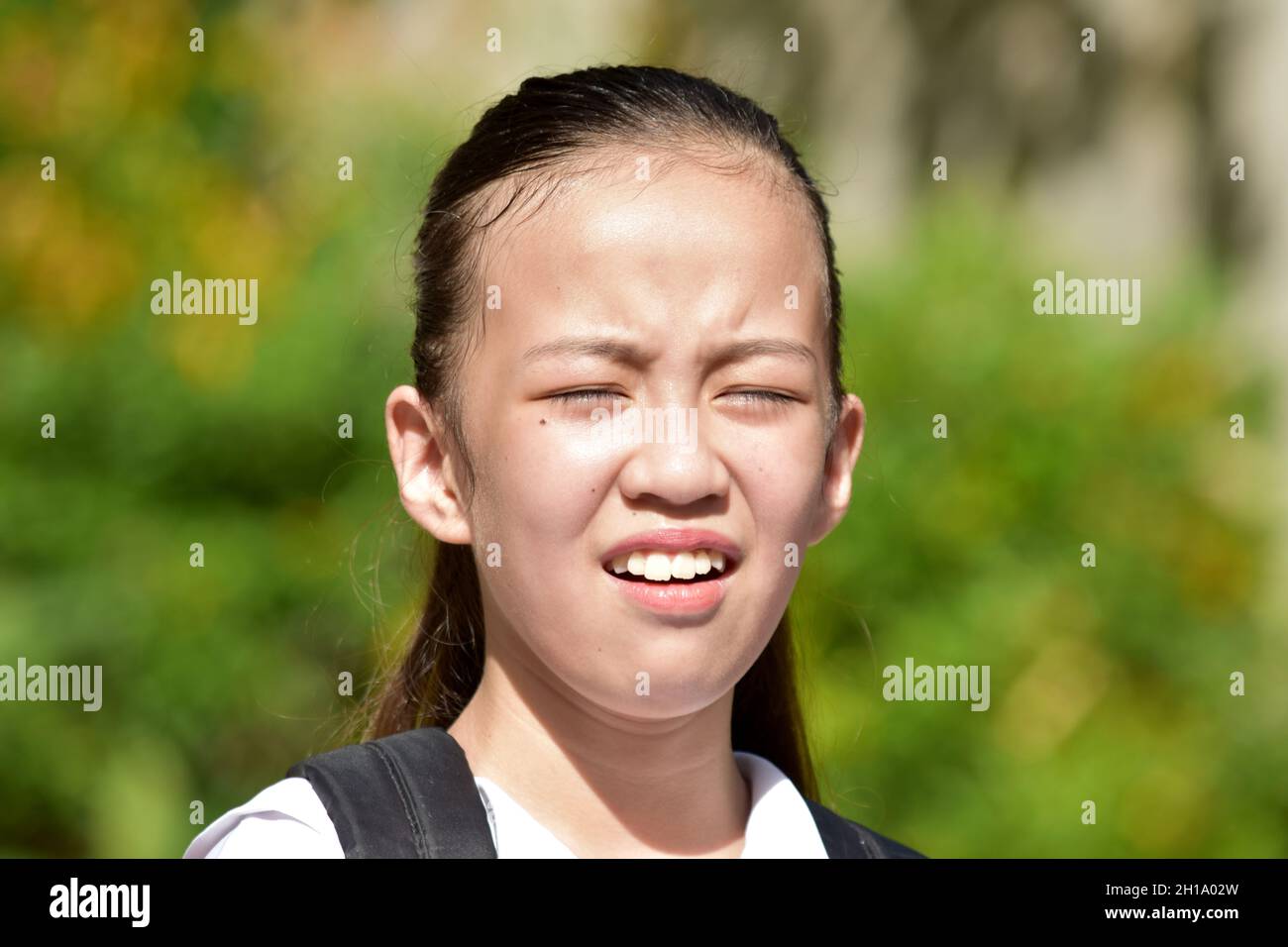Cute School Girl With Eyes Closed Stock Photo - Alamy