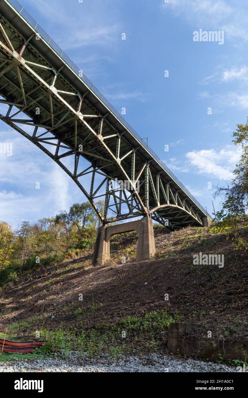 Old arch bridge viewed from beneath showing severe deterioration ...