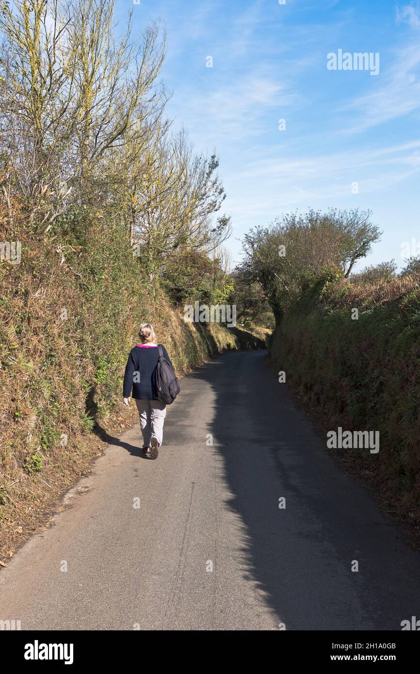 dh Country lane ROADS GUERNSEY Tourist woman walking down countryside ...
