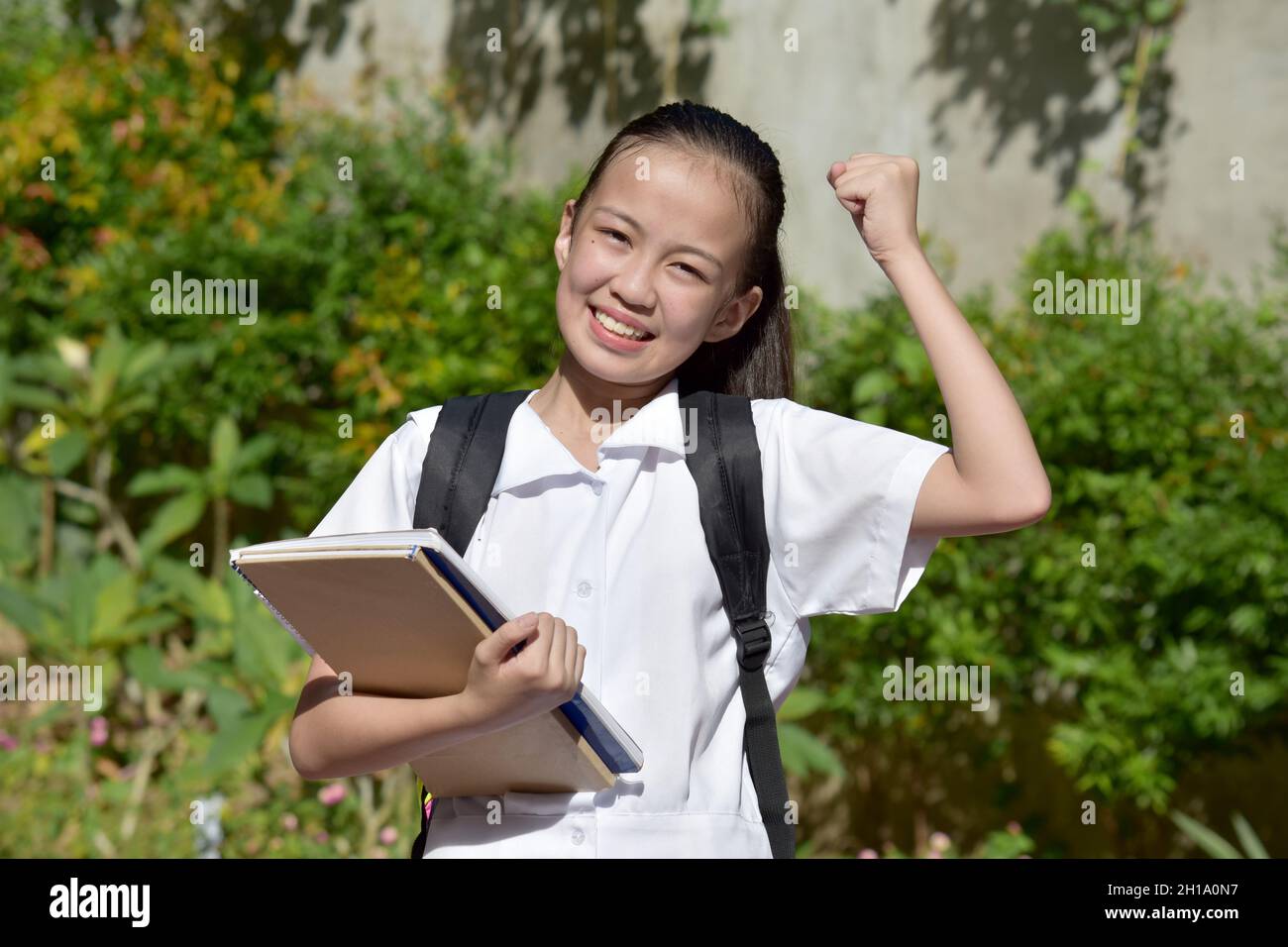 Successful Filipina Girl Student With Textbooks Stock Photo - Alamy