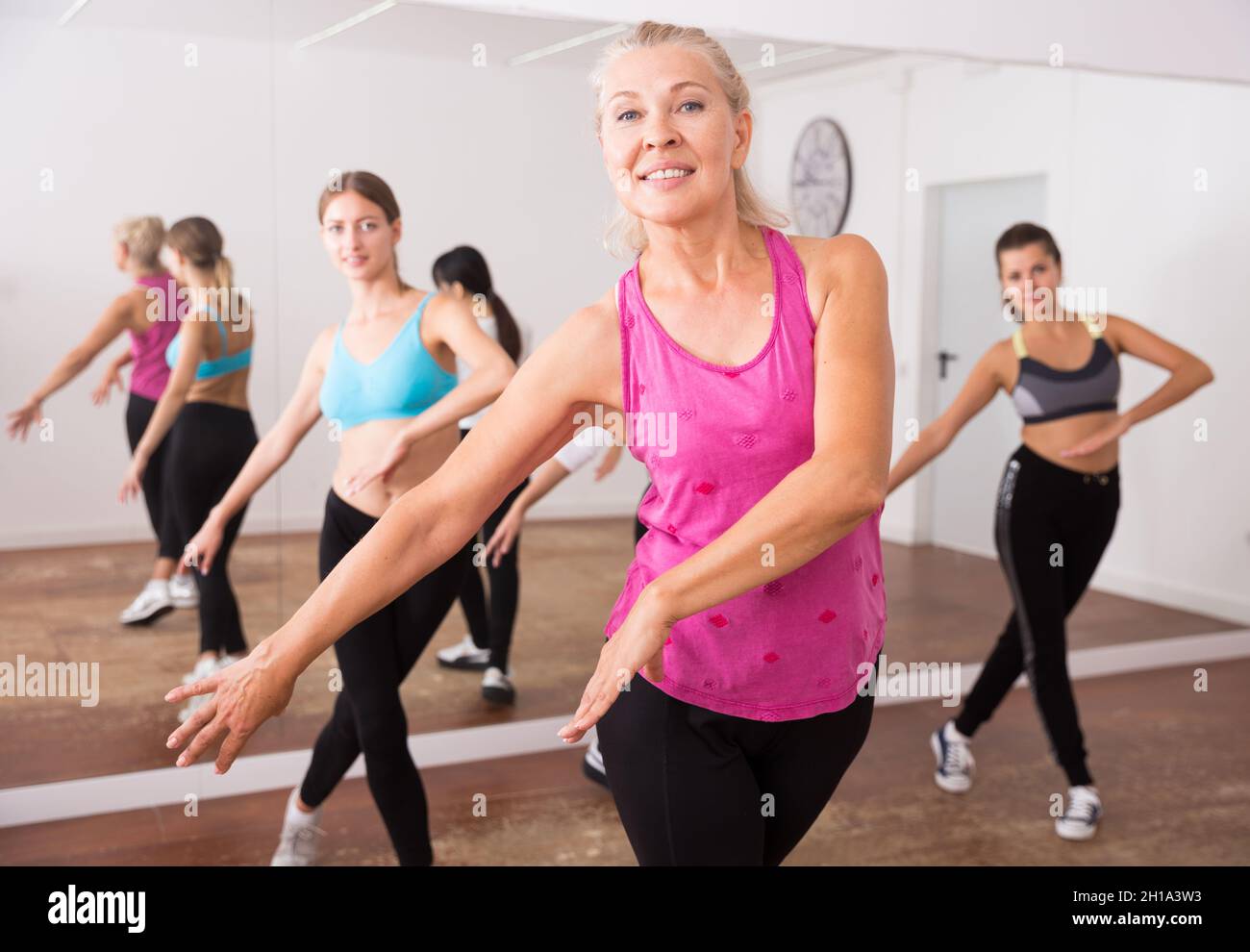 Group of active smiling people dancing together in dance studio Stock ...