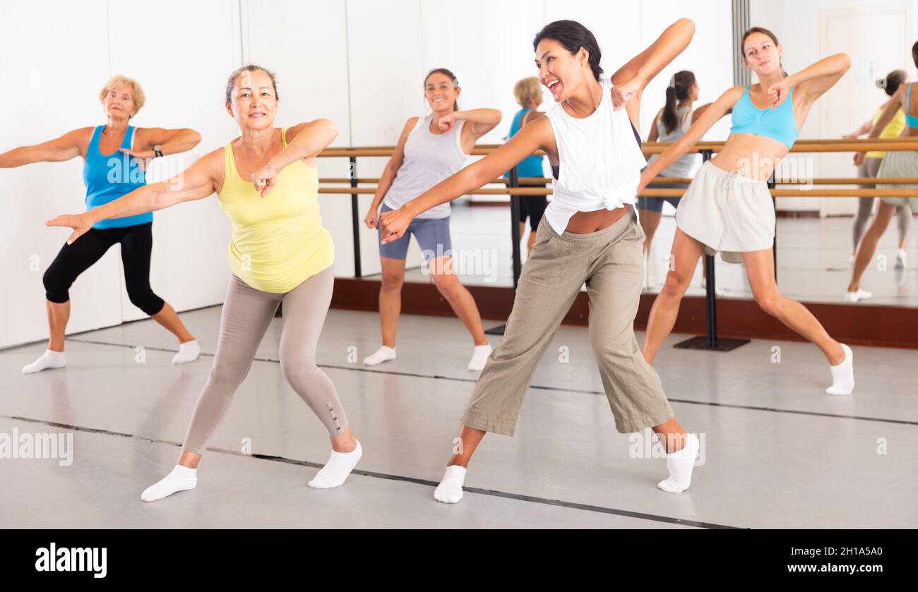 Group of active women practicing energetic dance in a studio Stock ...