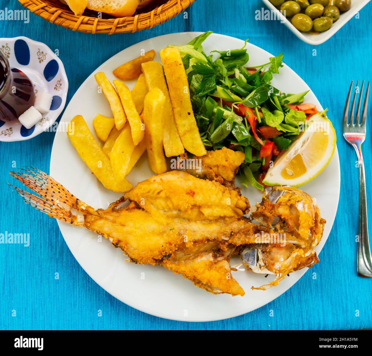 Sea food - lionfish with potatoes Stock Photo - Alamy