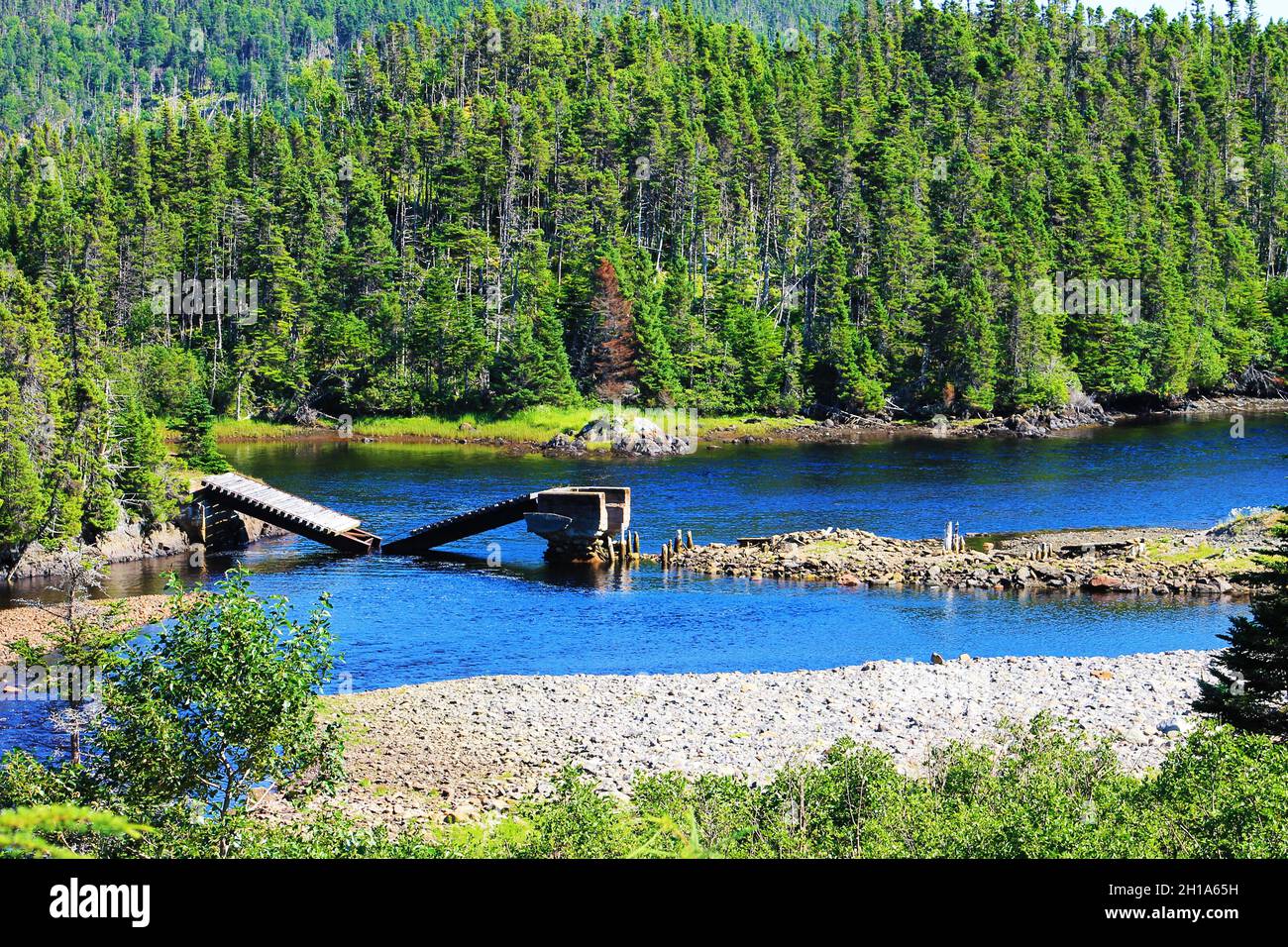 An old bridge split in the middle and collapsed into a river, Trinity ...