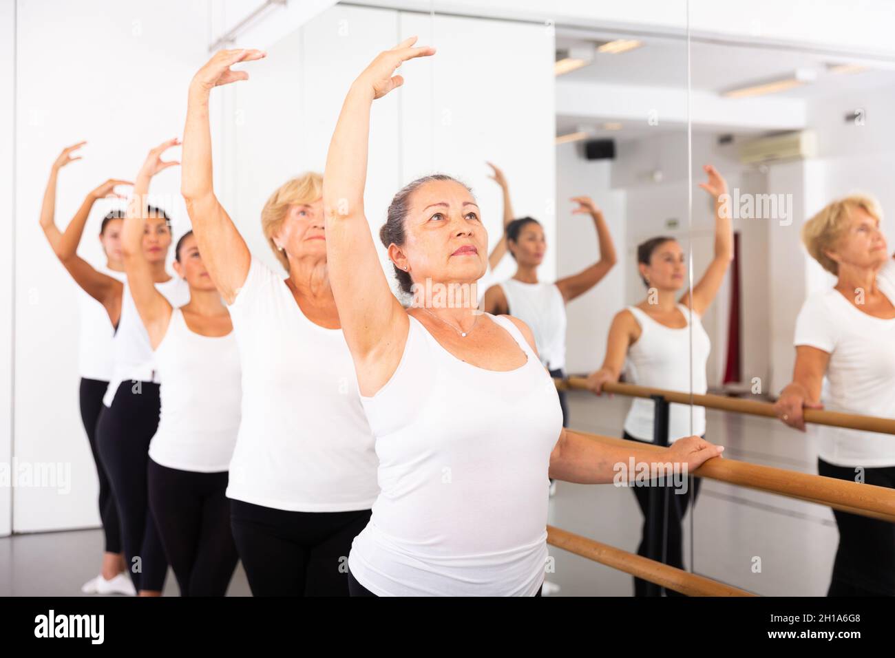 Group of women engaged in ballet standing in the 3rd position of the ...