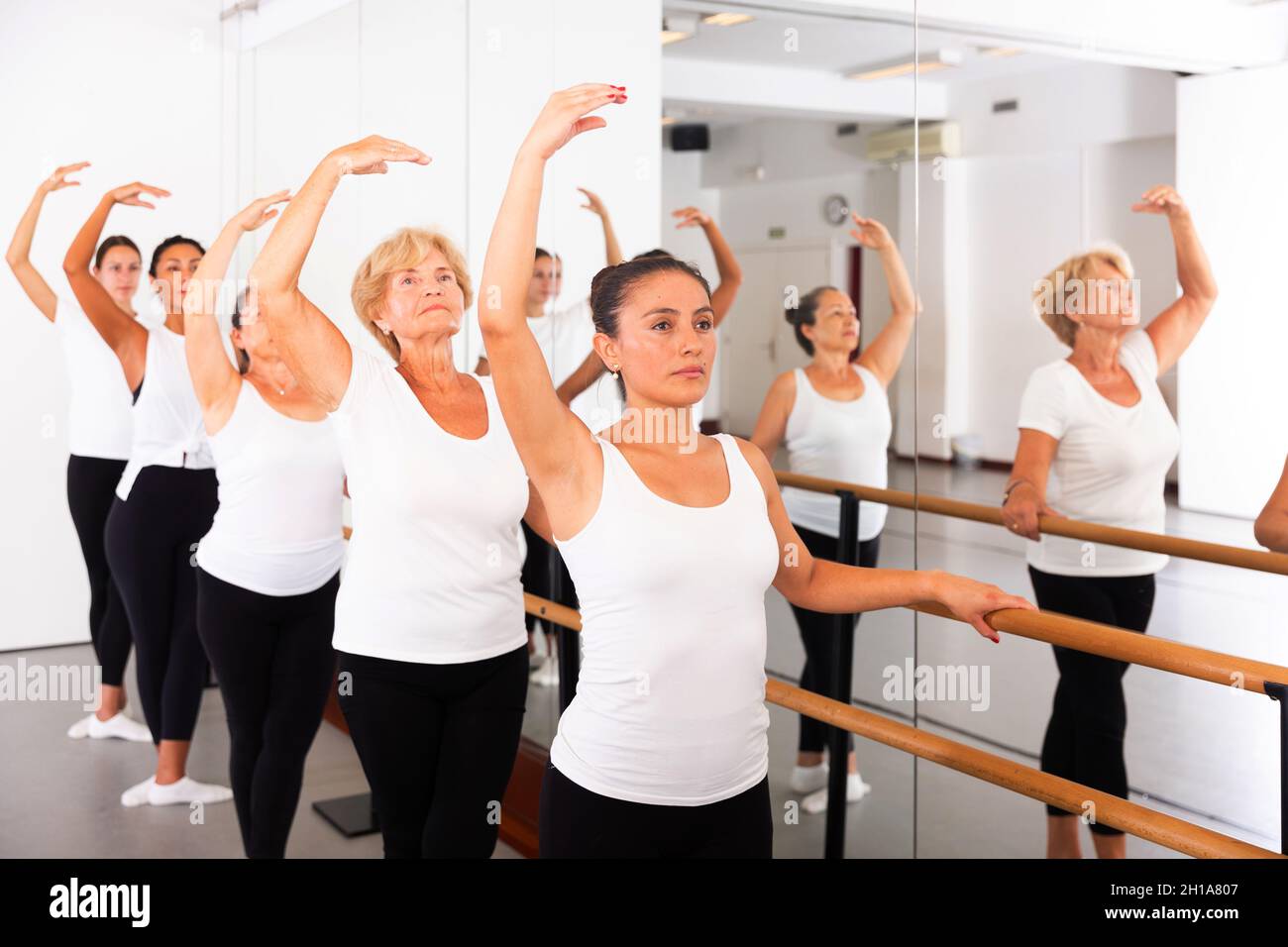Group of women engaged in ballet standing in the 3rd position of the ...