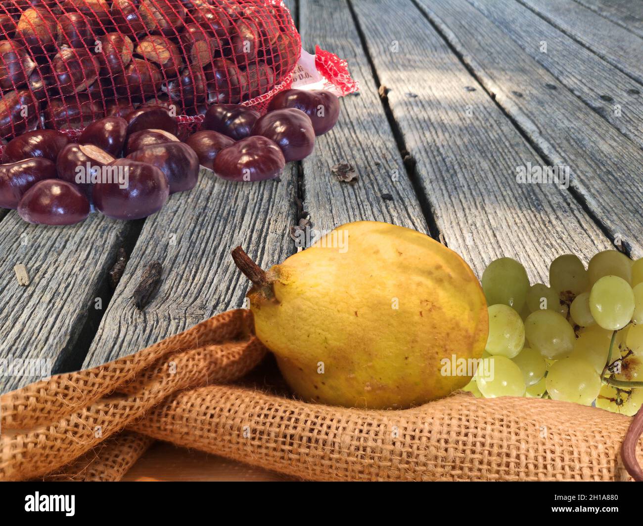 A pear, some grapes and chestnuts on long boards Stock Photo - Alamy