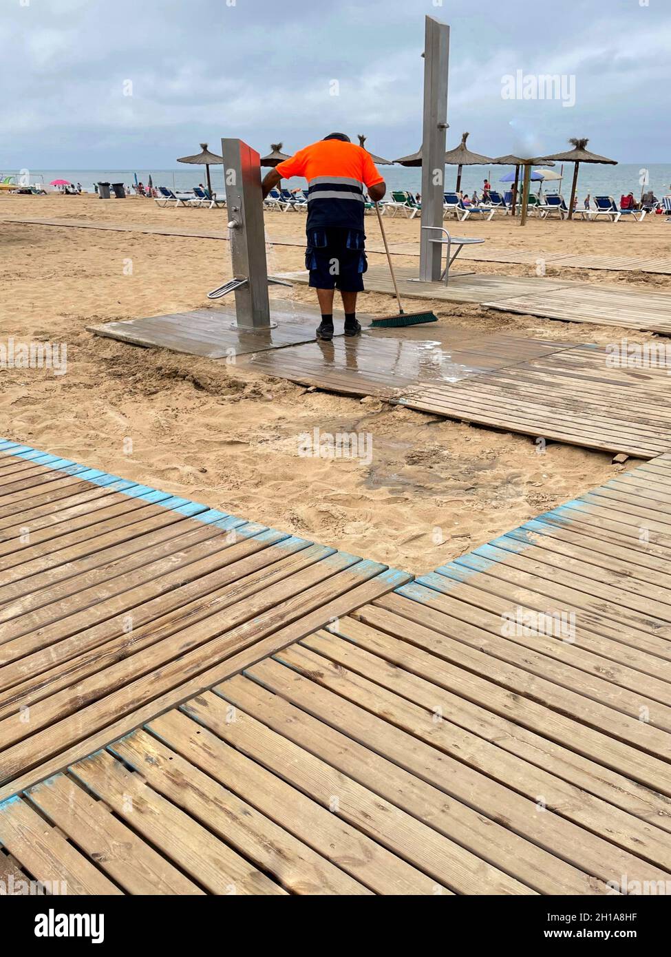 Vertical shot of a worker cleaning the beach area Stock Photo - Alamy