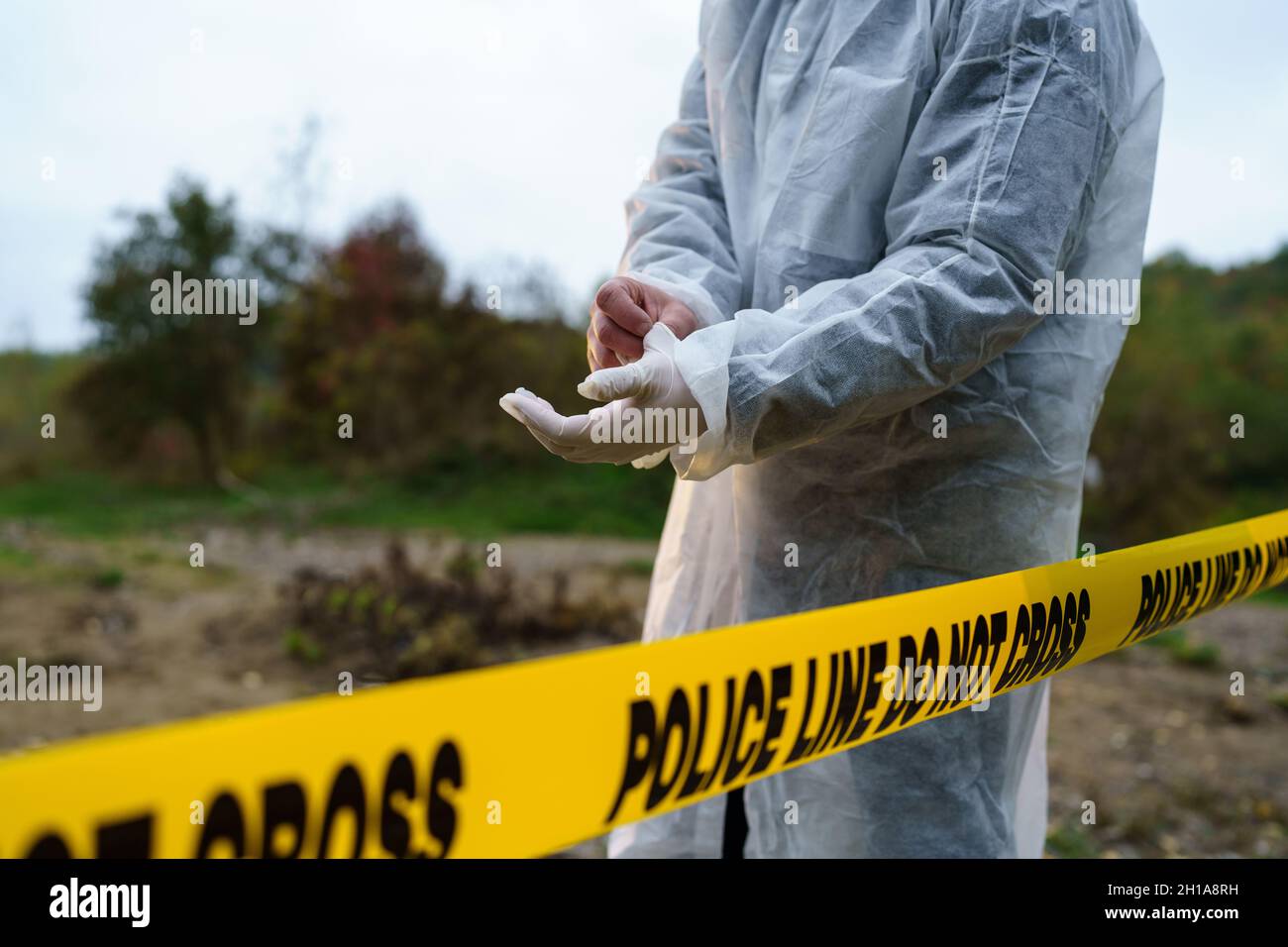 Crime investigation concept close up on hand of unknown forensic man ...