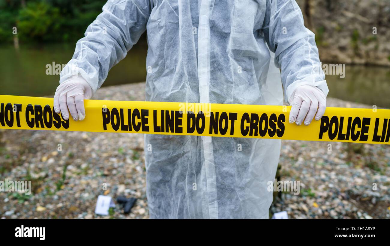 Crime scene tape hand hi-res stock photography and images - Alamy