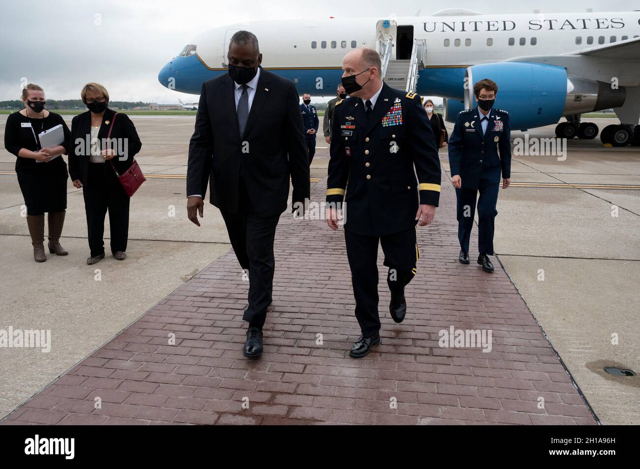 Secretary of Defense Lloyd J. Austin III walks with the outgoing ...