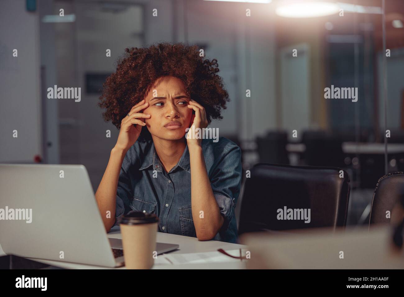Serious pretty lady working a lot in the office Stock Photo - Alamy