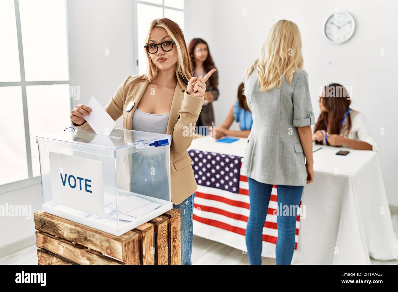 Group of young girls voting at democracy referendum pointing with hand ...