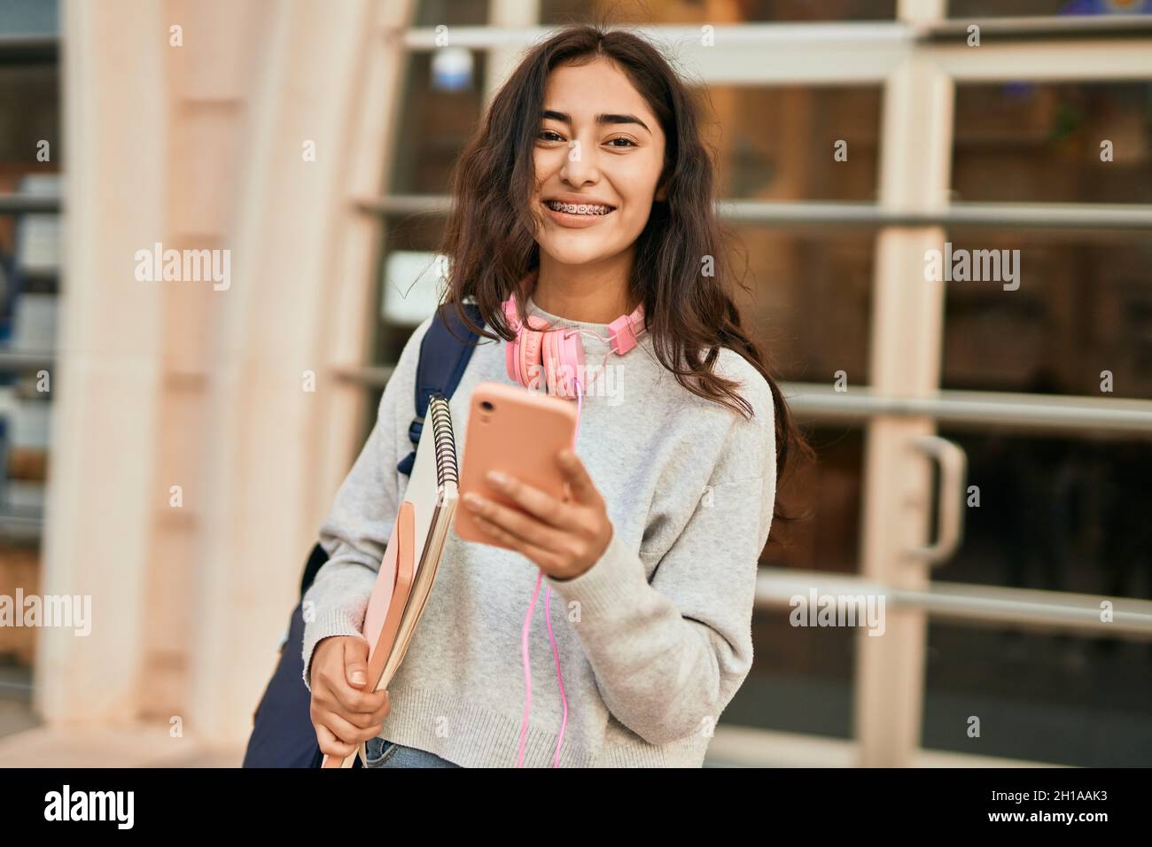 Young middle east student girl smiling happy using smartphone at the ...