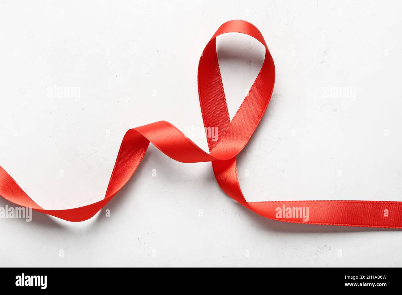 Shiny red ribbon on white background Stock Photo - Alamy