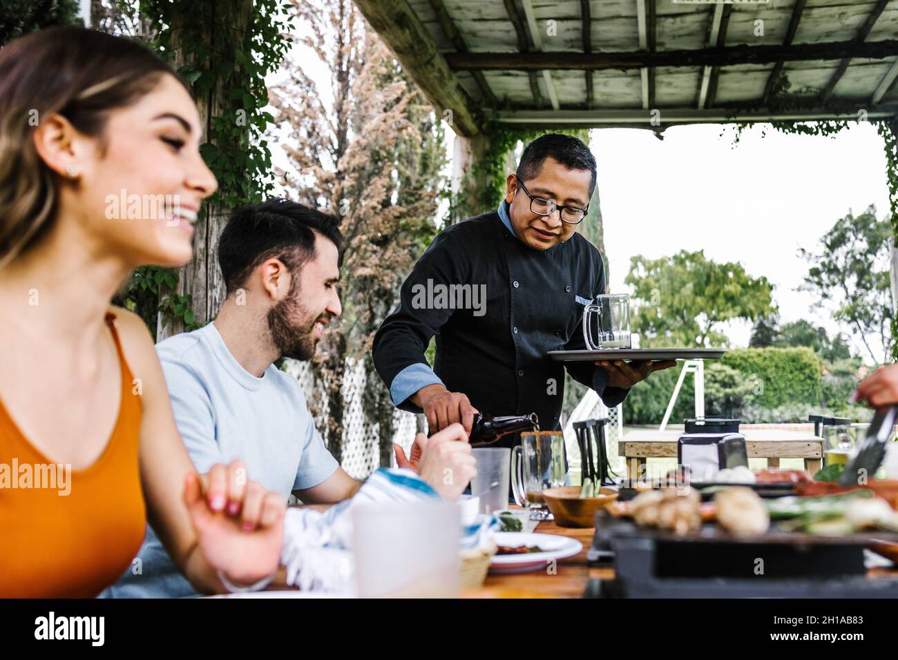 group of latin friends eating tacos in a mexican restaurant or bar ...