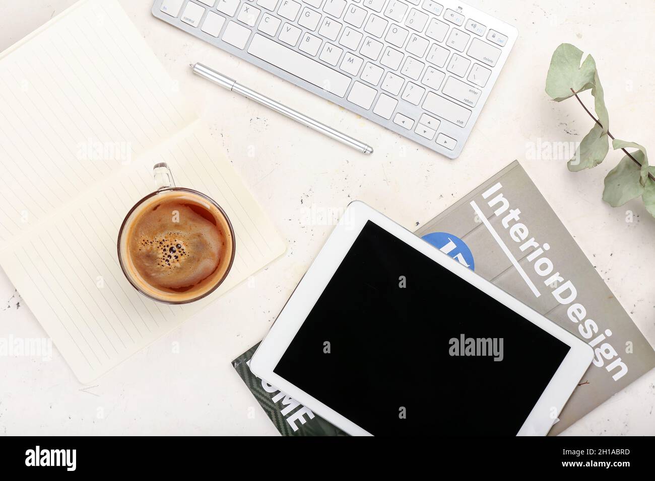 Composition with cup of coffee, tablet computer, notebook and keyboard ...