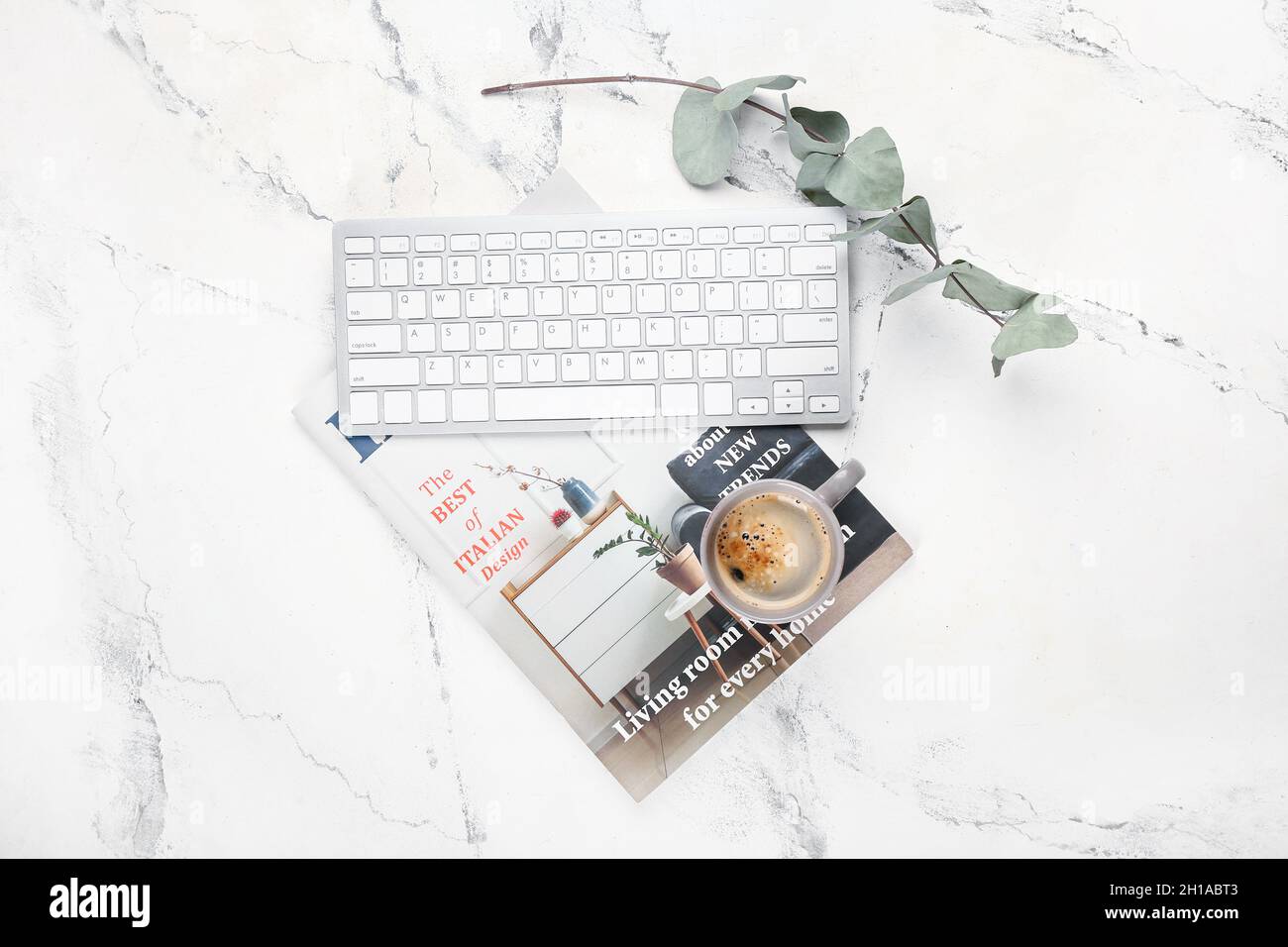 Composition with cup of coffee, magazine and keyboard on light ...