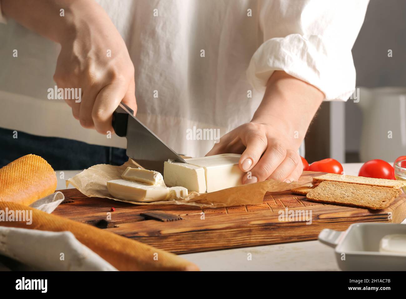 Woman cutting feta cheese hi-res stock photography and images - Alamy