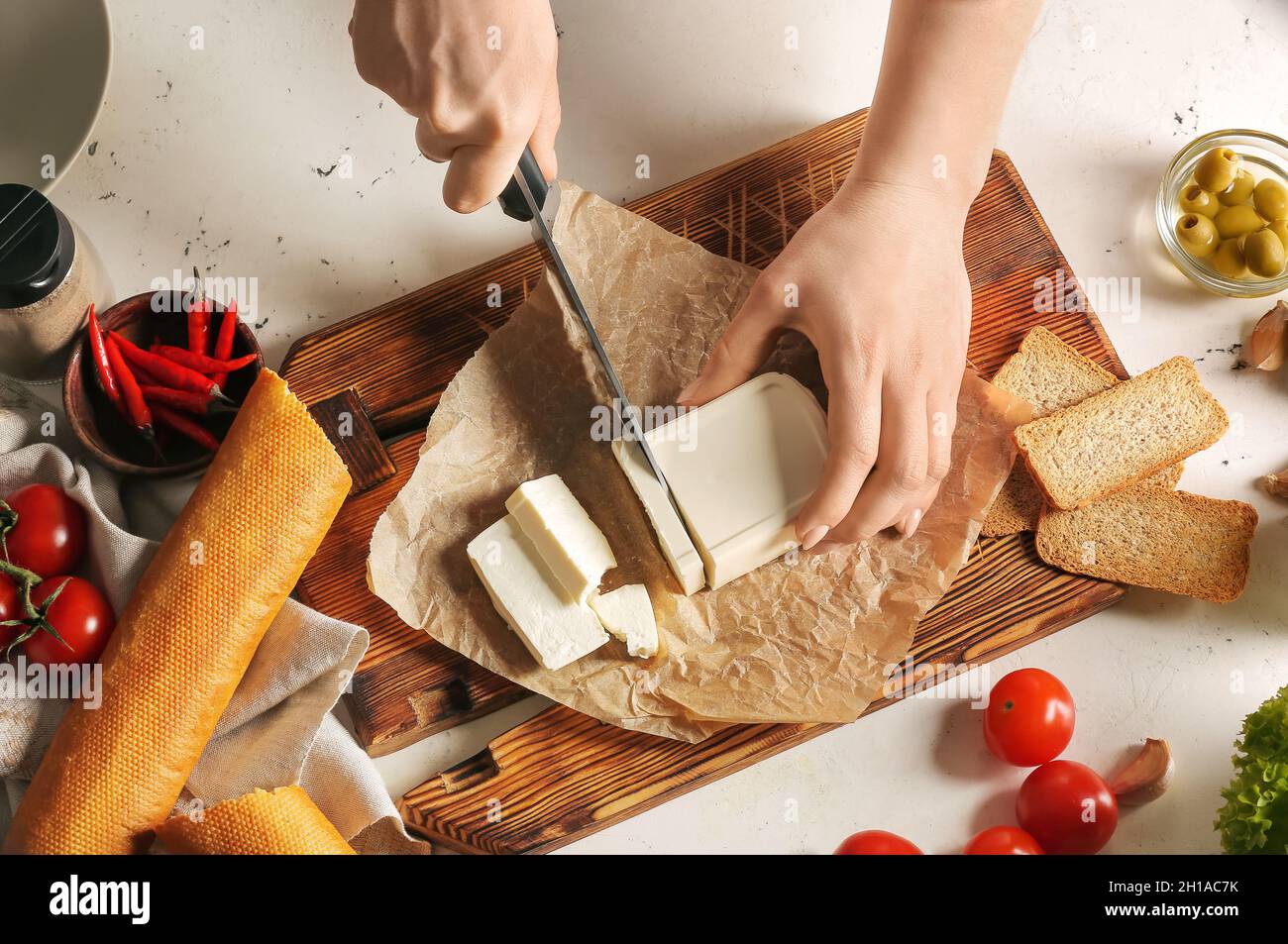 Woman cutting feta cheese hi-res stock photography and images - Alamy