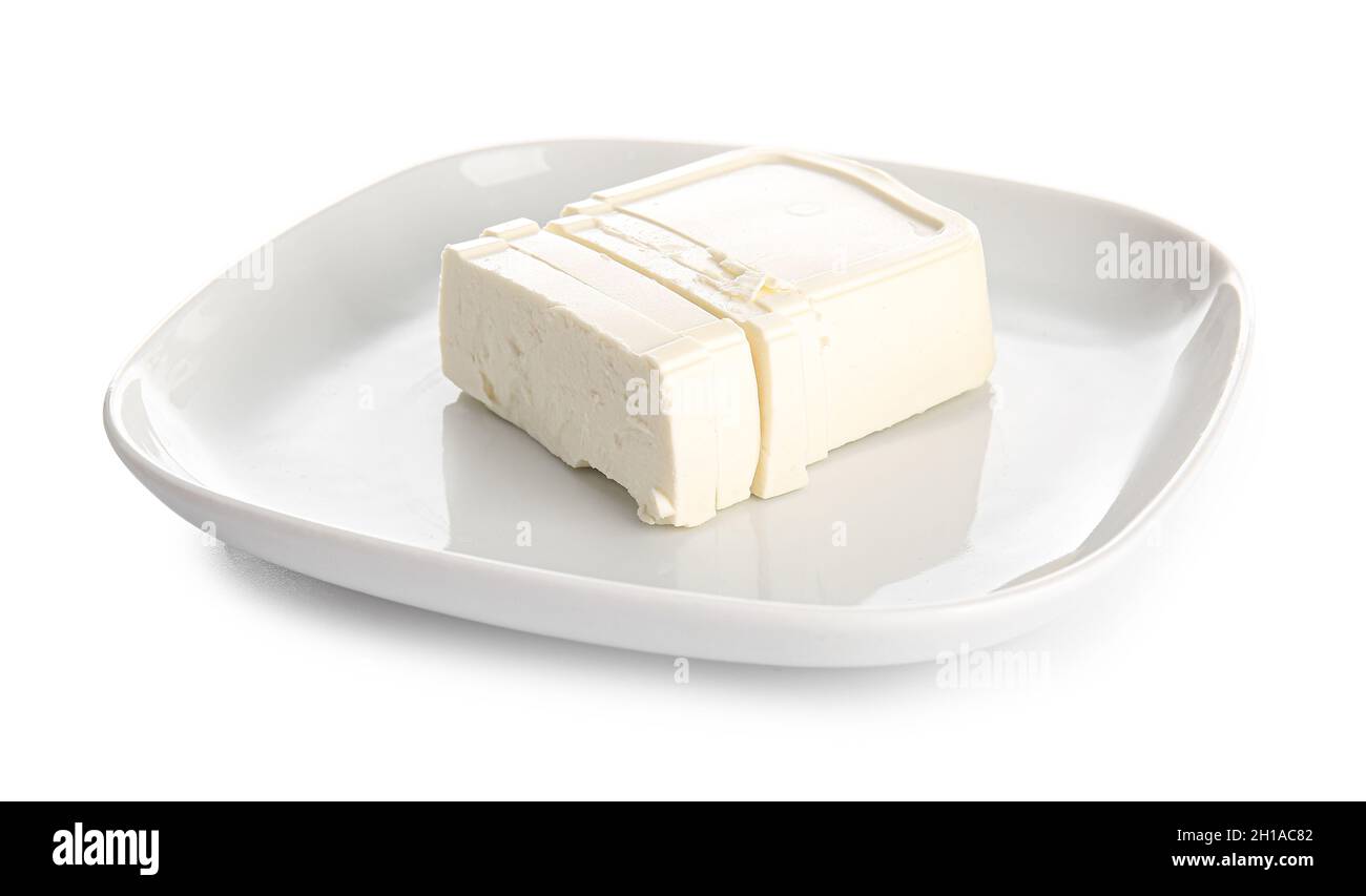 Plate with cut feta cheese on white background Stock Photo - Alamy