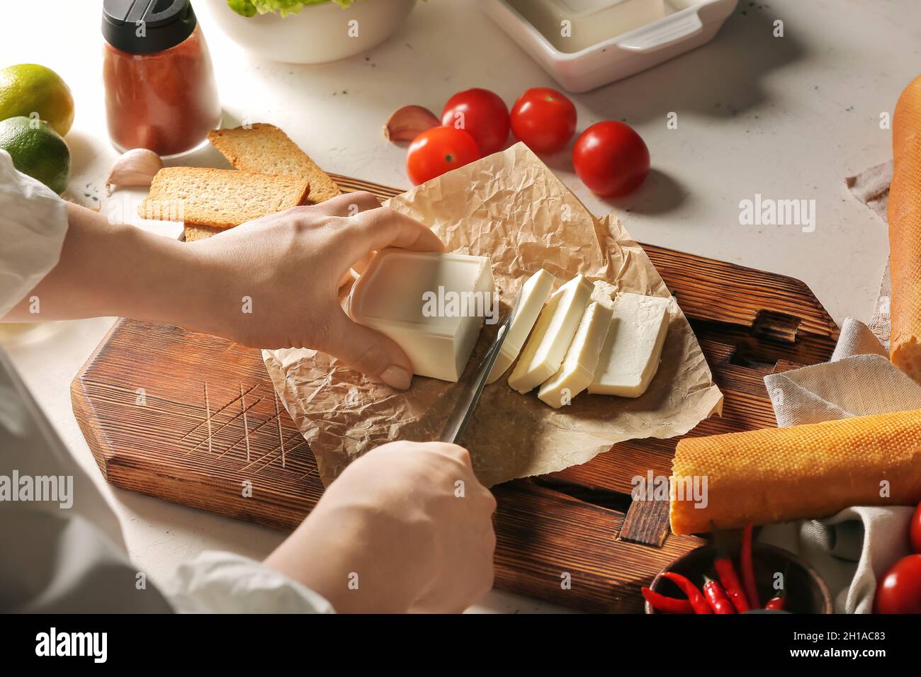 Woman cutting feta cheese hi-res stock photography and images - Alamy