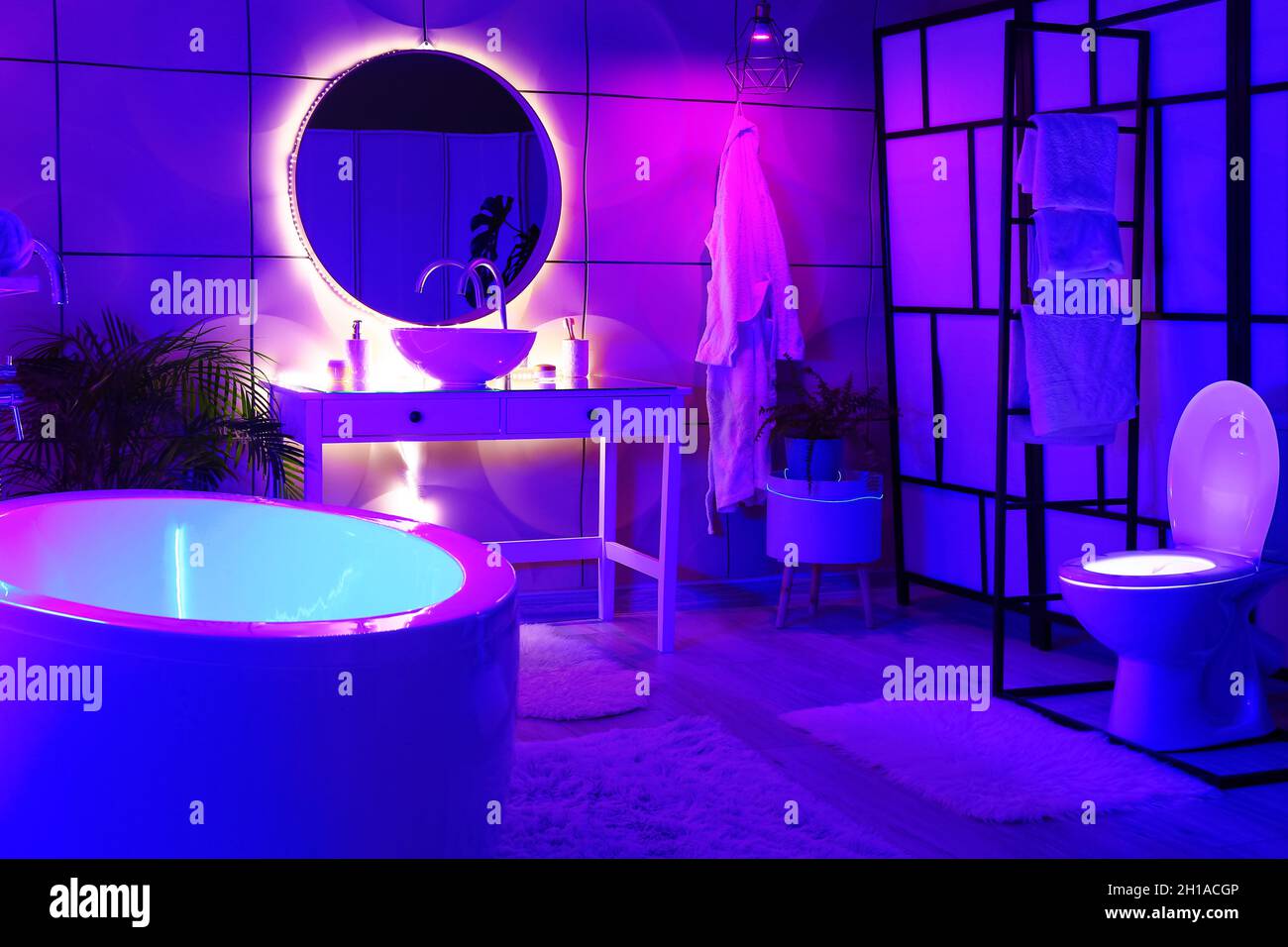 Interior of stylish bathroom with neon lighting Stock Photo - Alamy