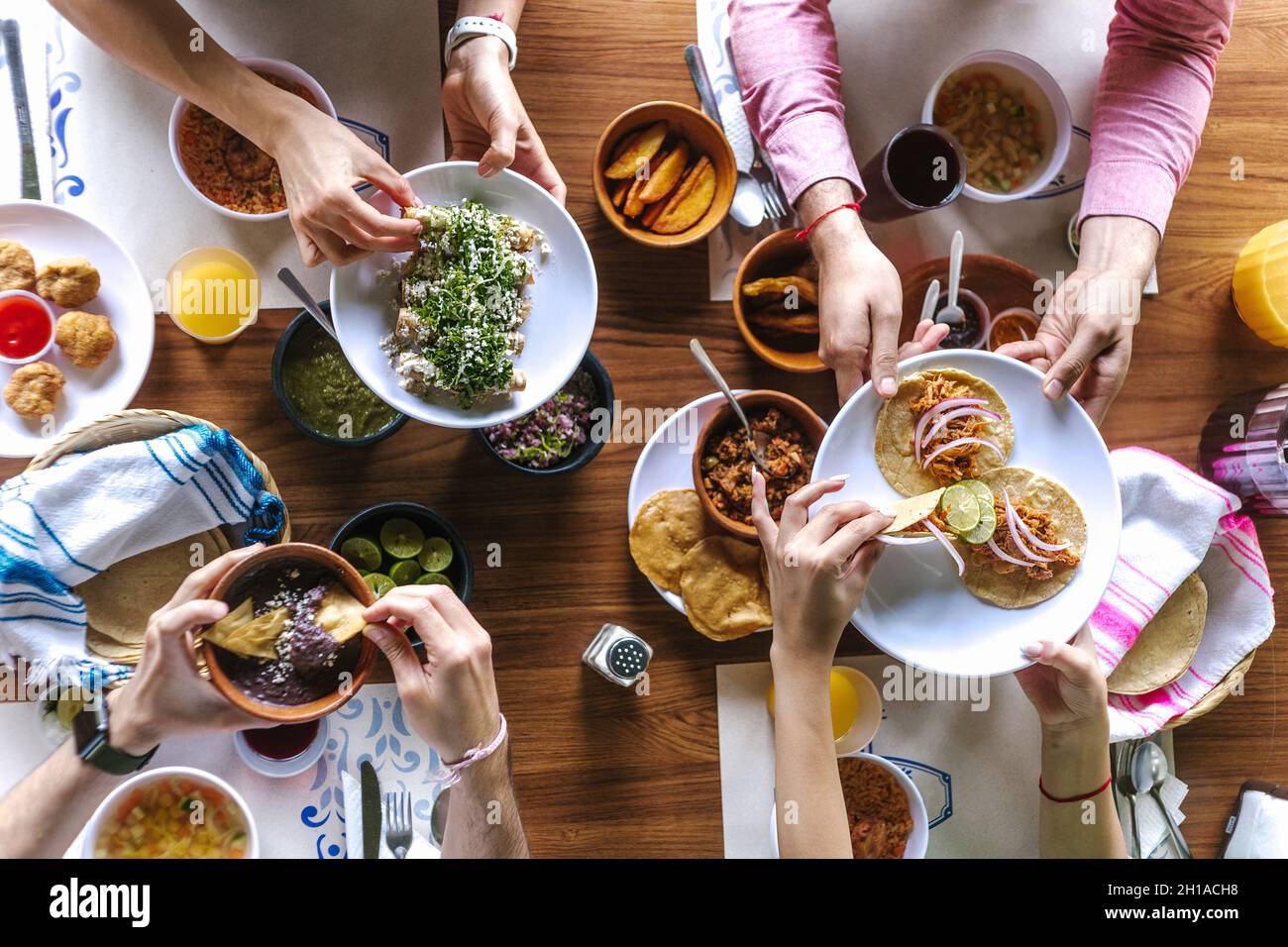 group of Friend eating Mexican Tacos and traditional food, snacks and ...