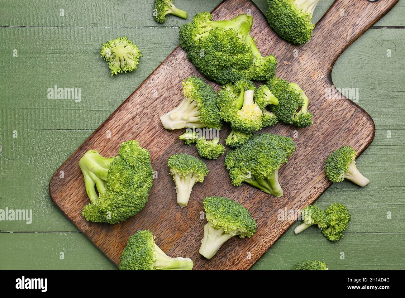 Board with healthy broccoli cabbage on color wooden background Stock ...