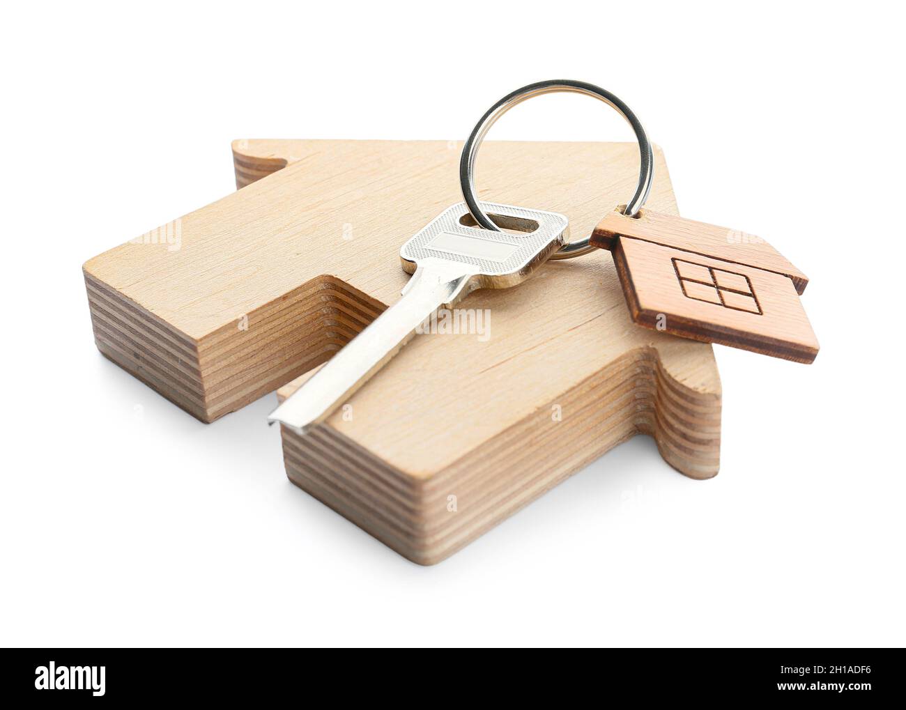 Key with keychain and figure of house on white background Stock Photo ...