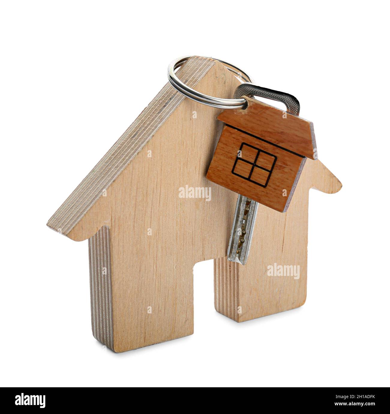 Miniature real estate house and key with keychain on white background ...