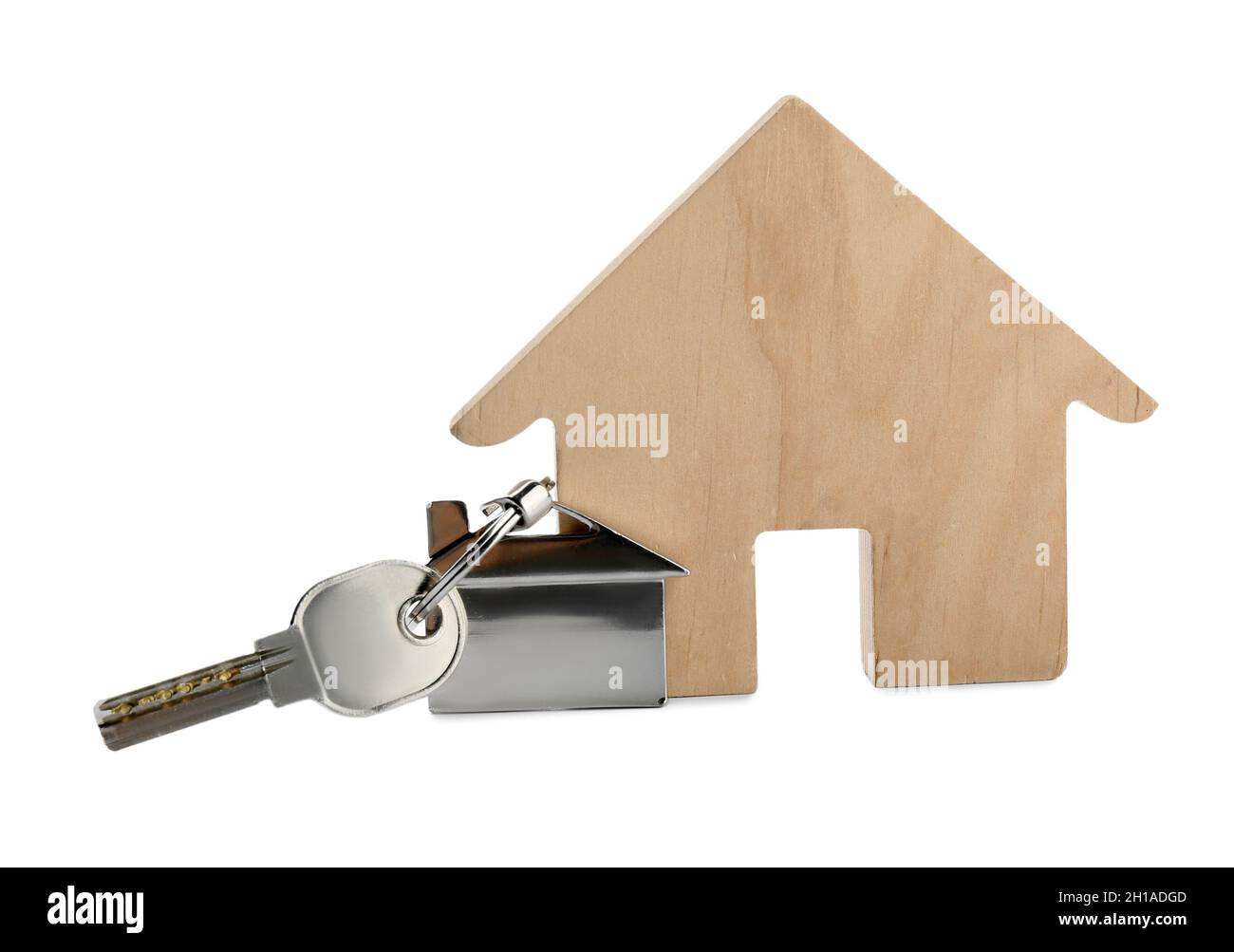 Home key with keychain and wooden figure of house on white background ...