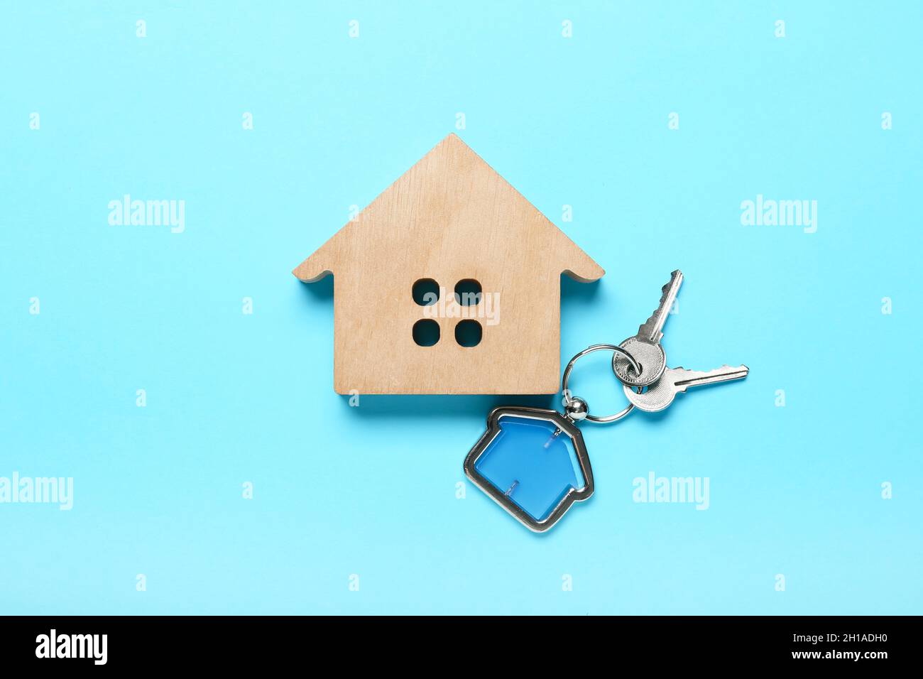 Figure of house and keys with keychain on color background Stock Photo ...
