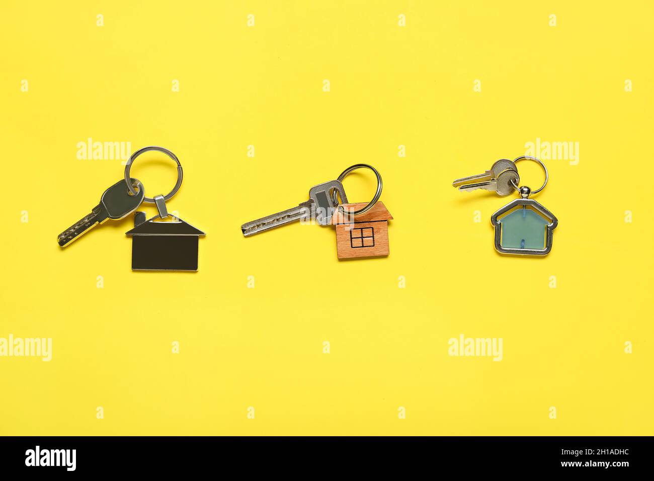 House keys with keychains on color background Stock Photo - Alamy
