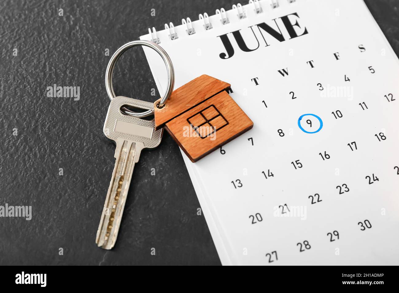 Calendar with pay rent mark and key with wooden house shaped keychain ...