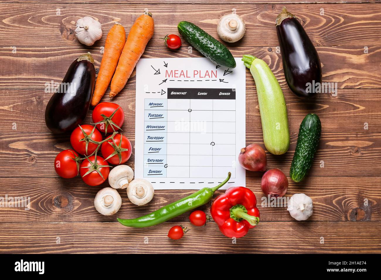 Healthy products with meal plan on wooden background Stock Photo - Alamy