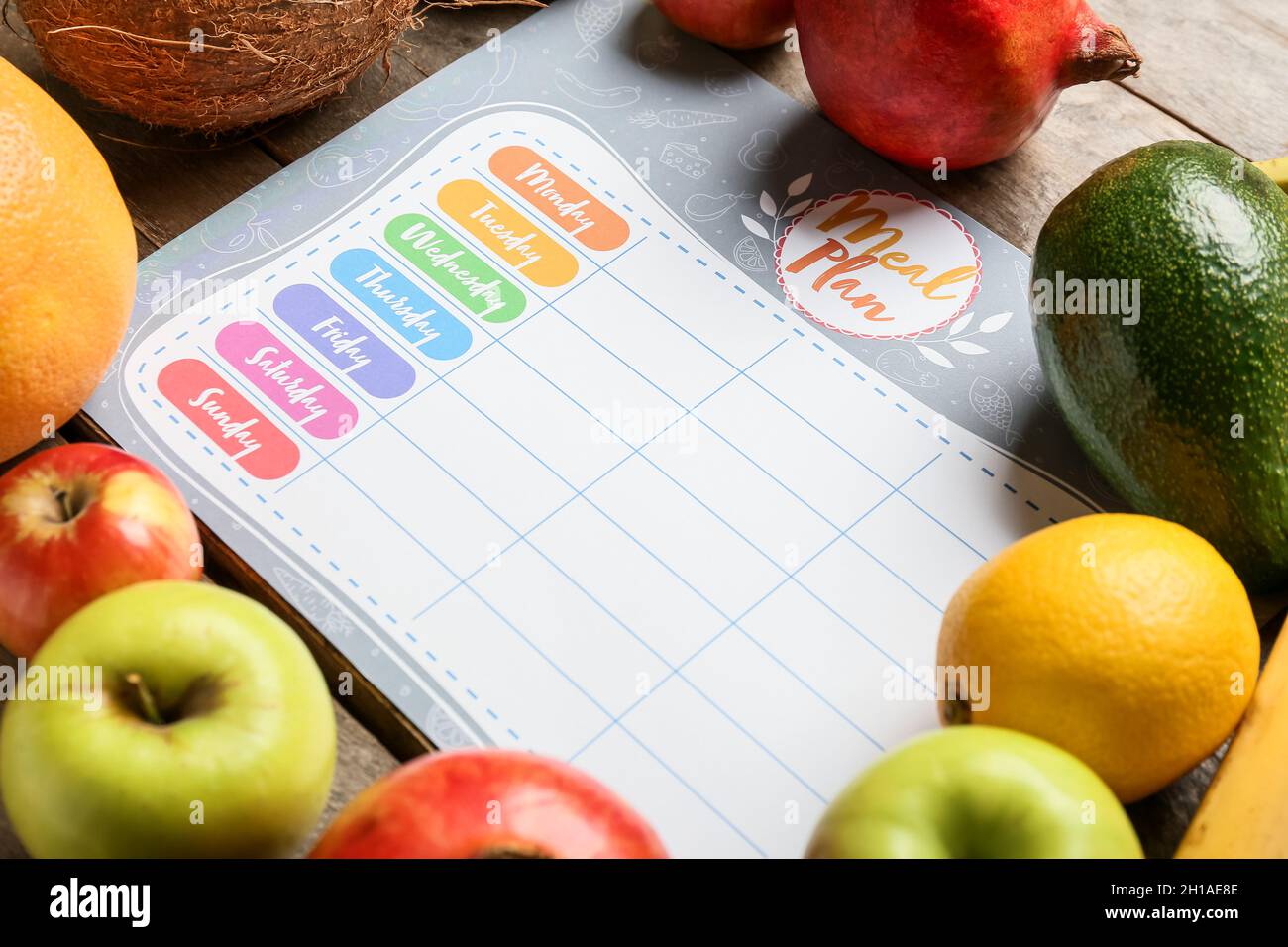 Fresh fruits with meal plan on table, closeup Stock Photo - Alamy