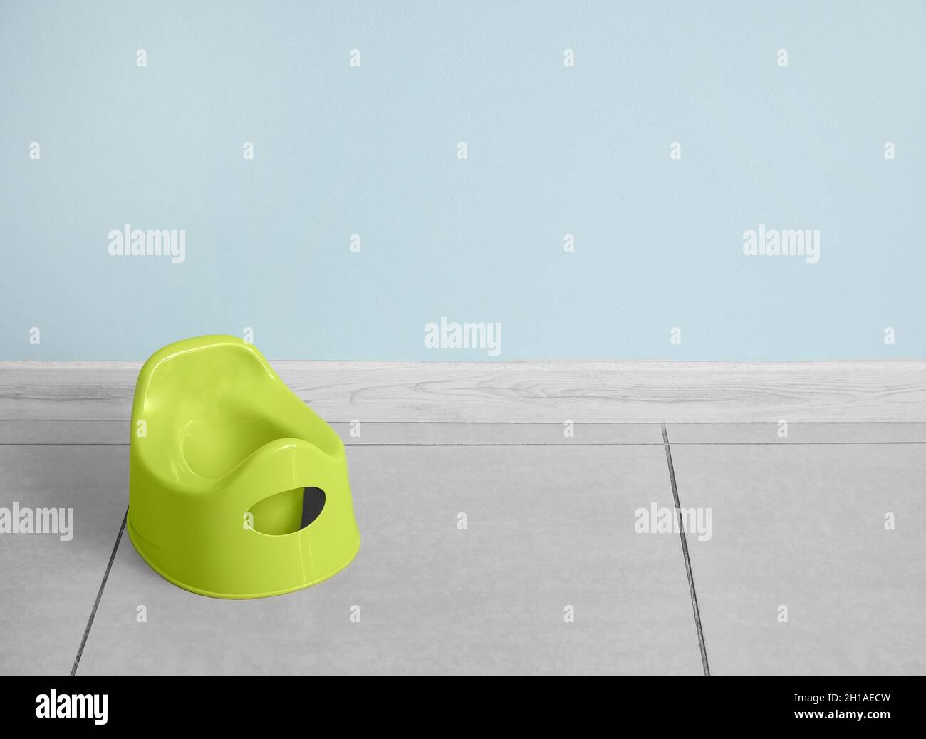 Potty on tile floor near color wall Stock Photo - Alamy