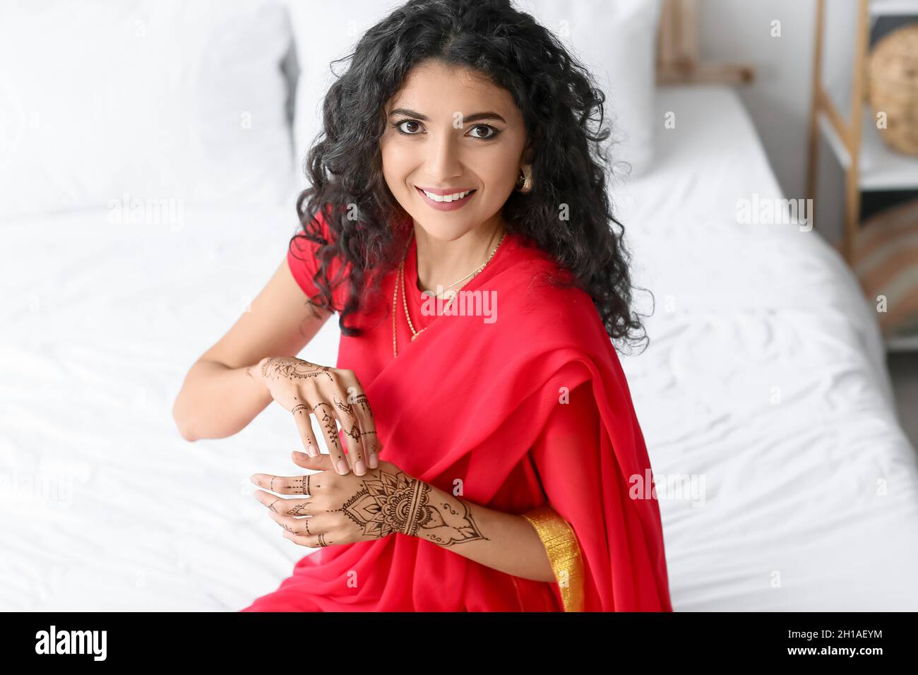 Beautiful Indian woman with henna tattoo at home Stock Photo - Alamy