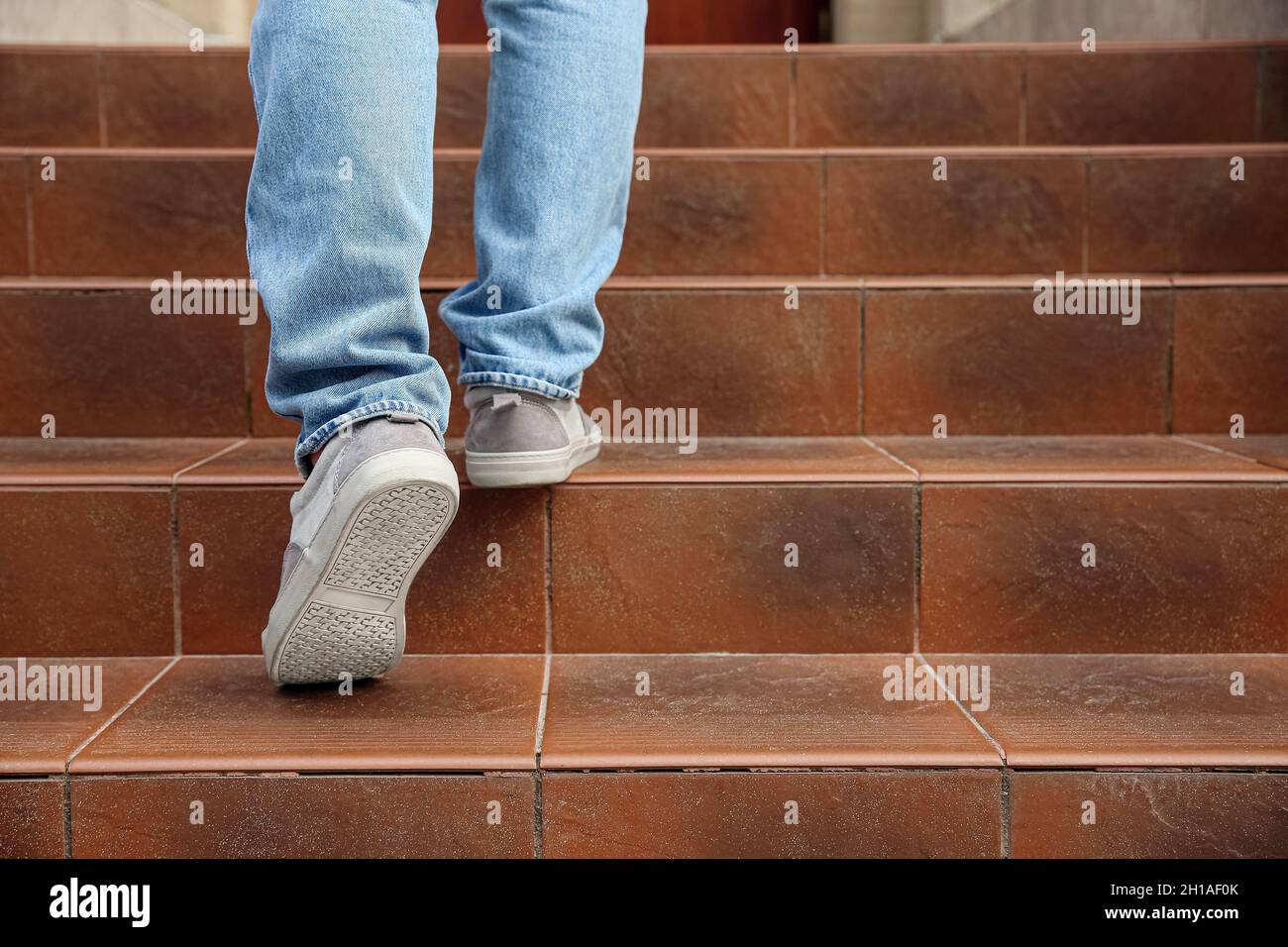 Man walking up the stairs outdoors Stock Photo - Alamy