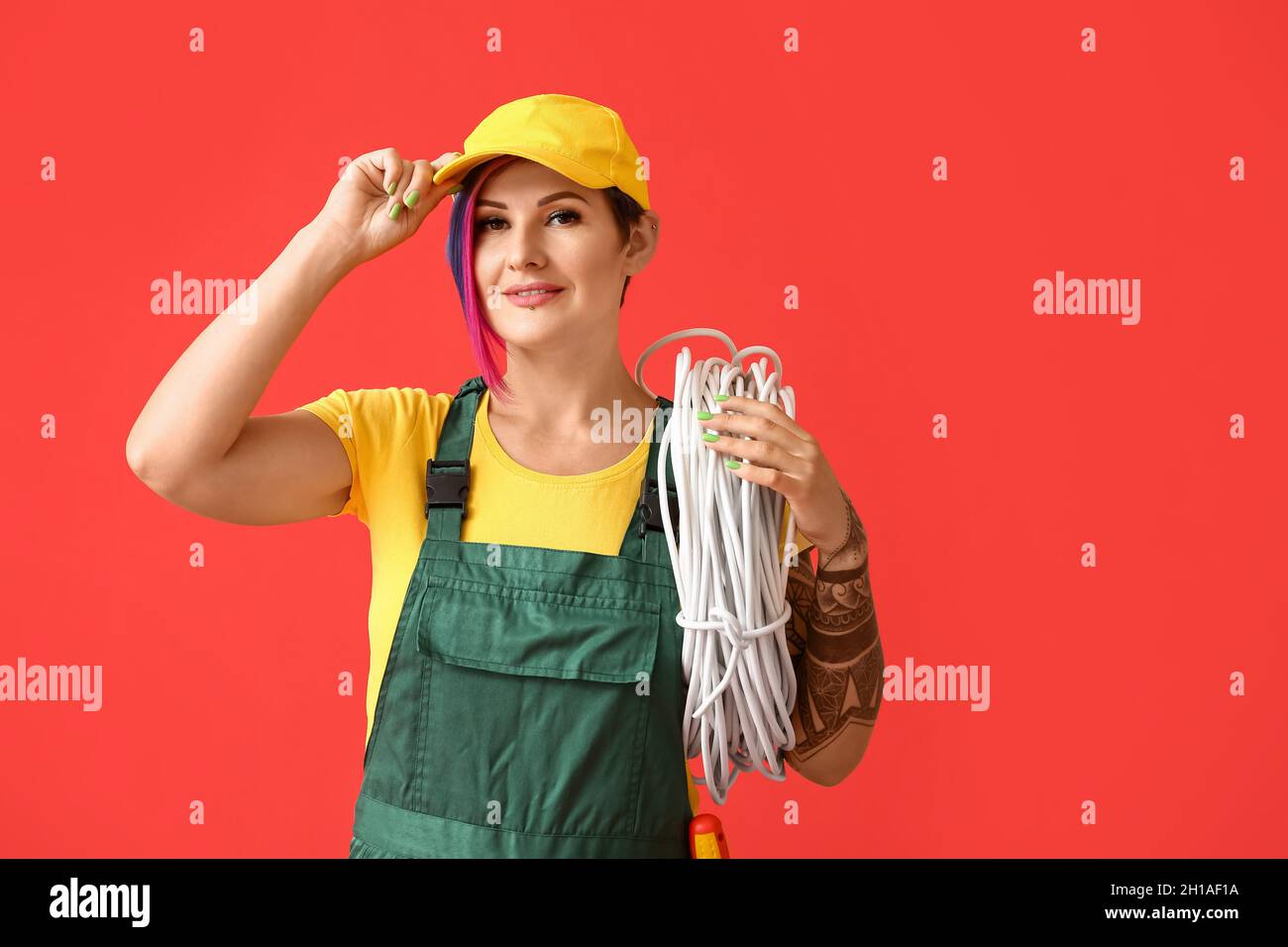 Female electrician red cable hi-res stock photography and images - Alamy