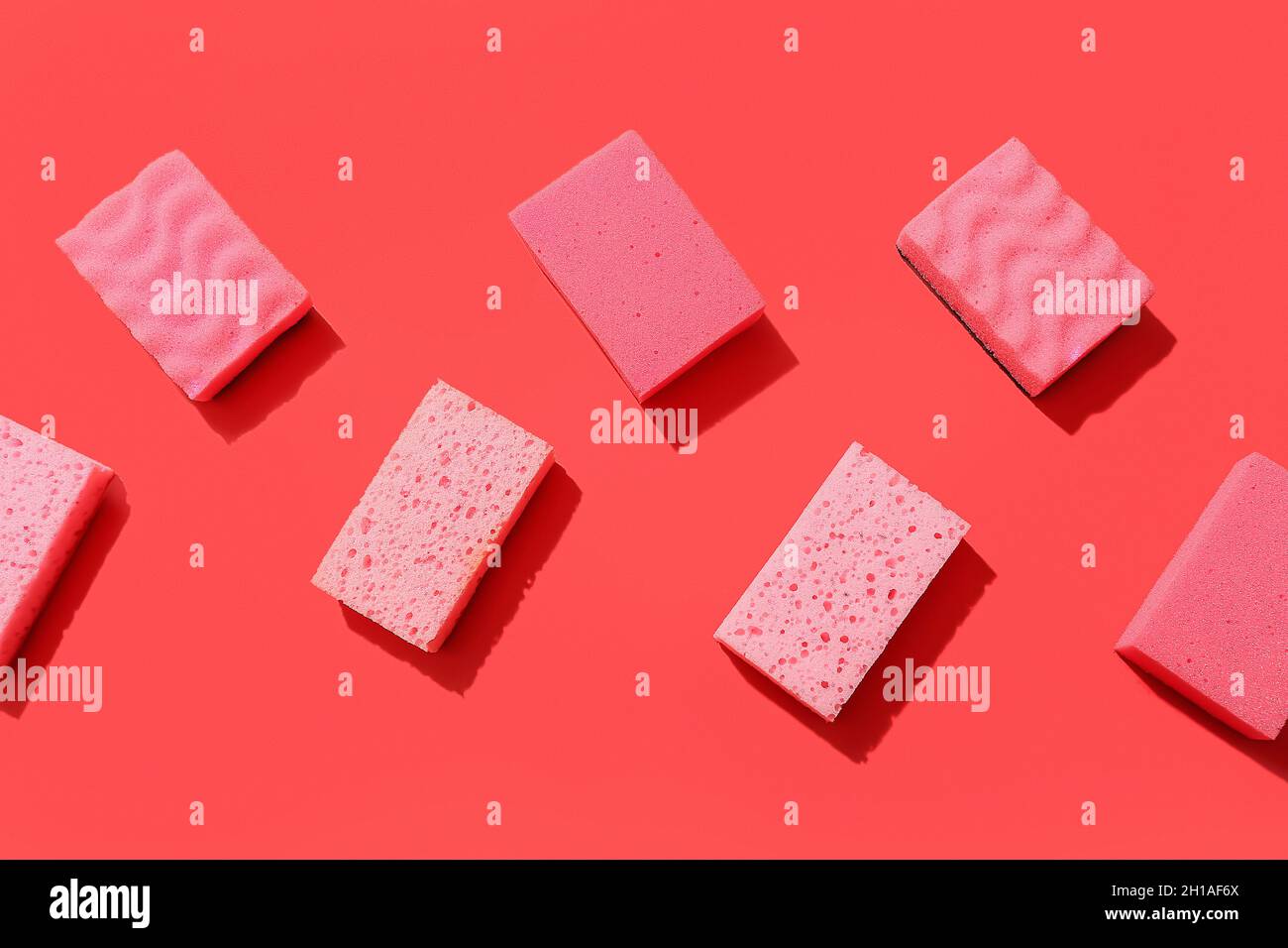 Cleaning sponges on red background Stock Photo - Alamy