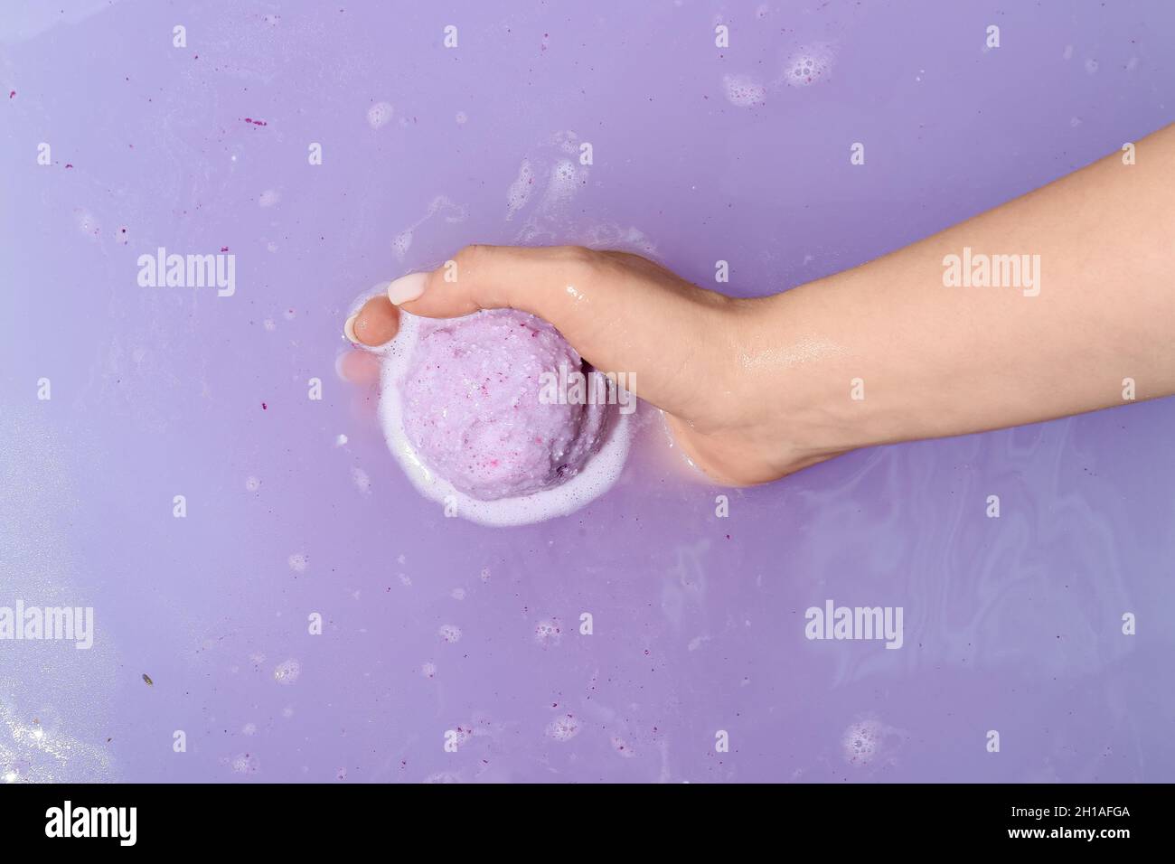 Hand putting bath bomb water hi-res stock photography and images - Alamy