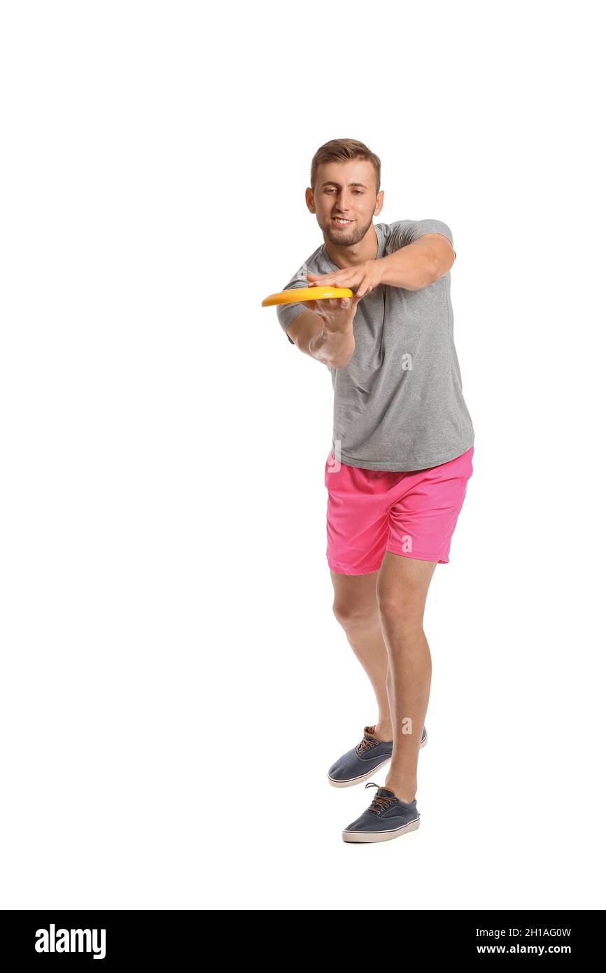 Handsome young man throwing frisbee on white background Stock Photo - Alamy