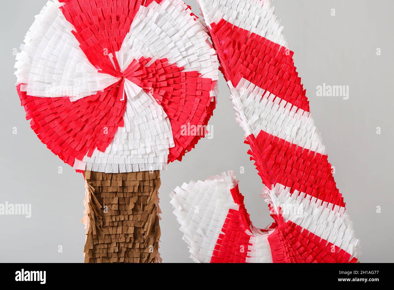 Mexican pinatas in shape of lollipop and cane on light background Stock ...