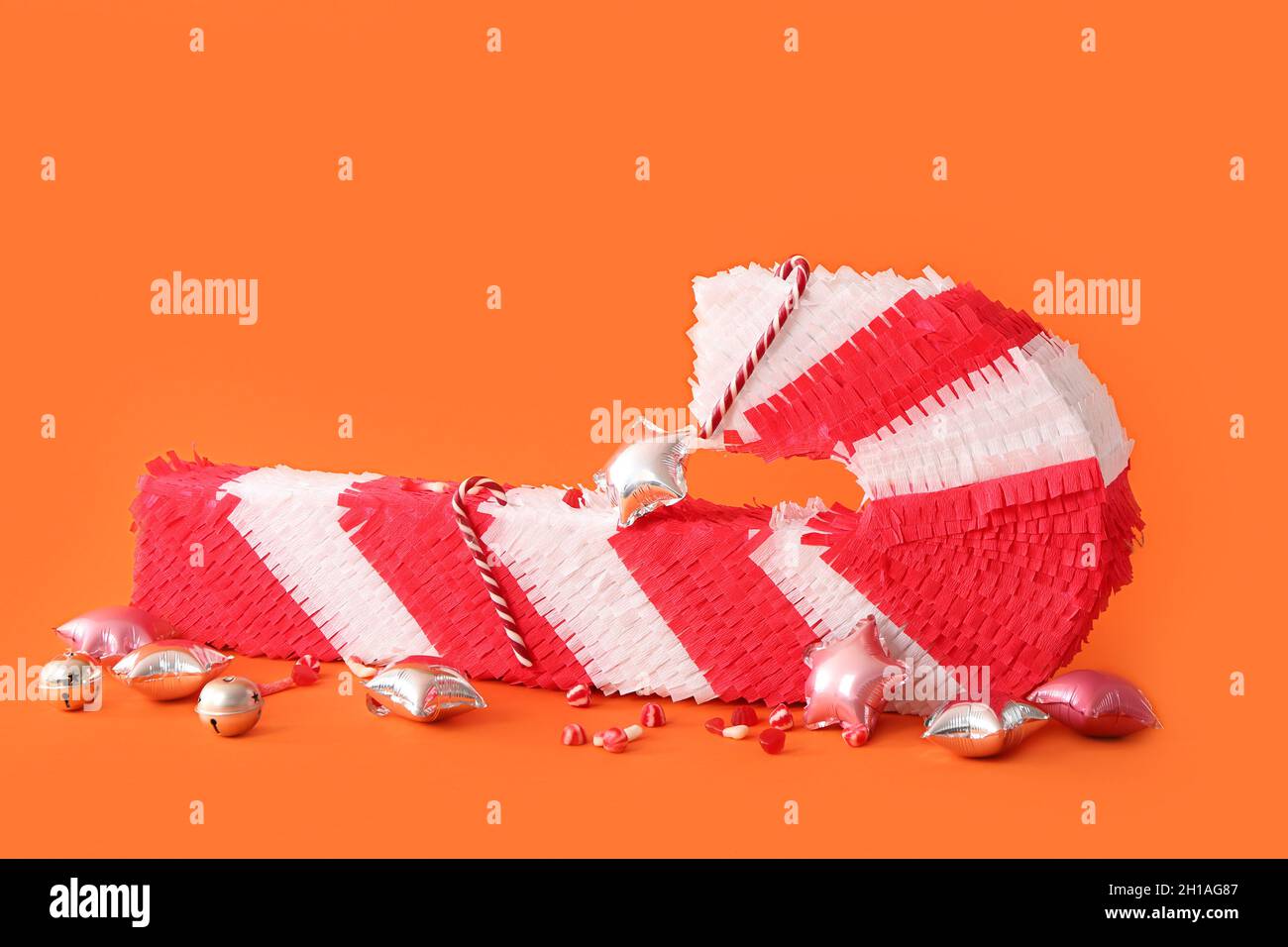 Mexican pinata with candies and balloons on color background Stock ...