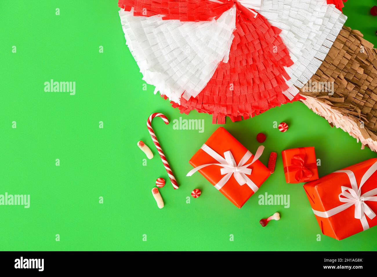 Mexican pinata with candies and gifts on green background Stock Photo ...